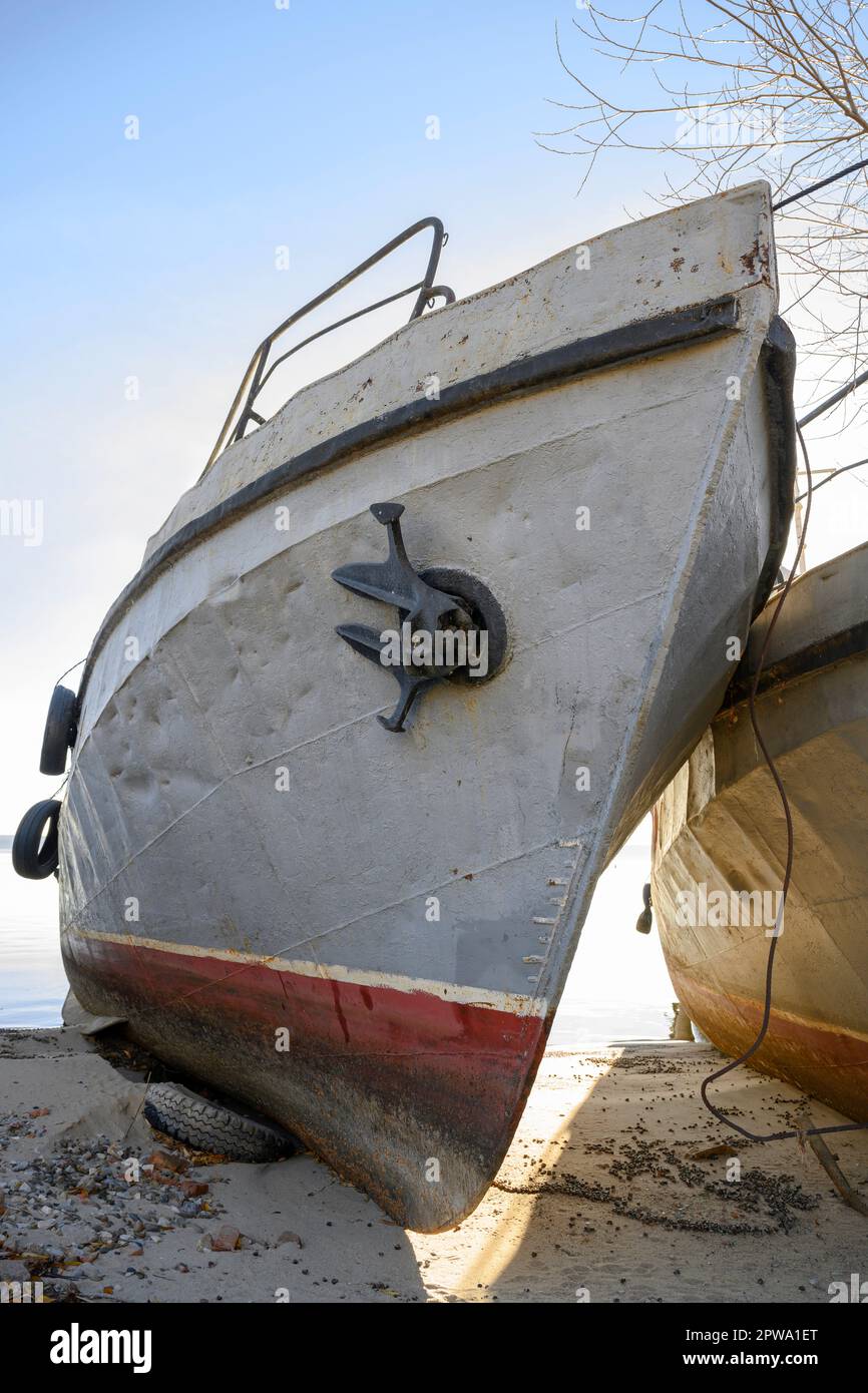 View of the bow of an old sad rusty fishing vessel pulled ashore Stock ...