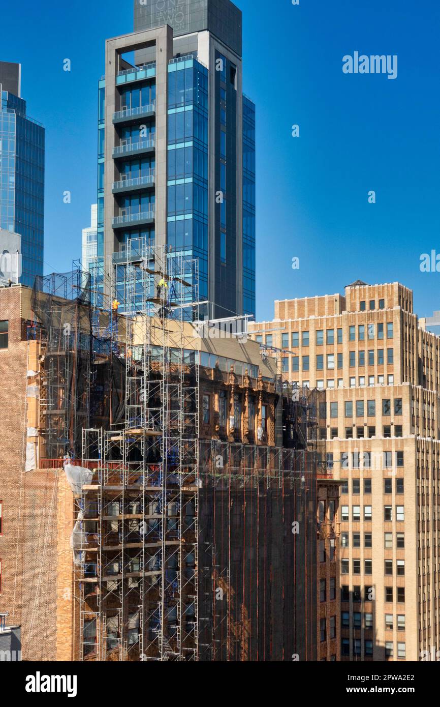 Workers constructing repointing scaffolding on an office building on ...
