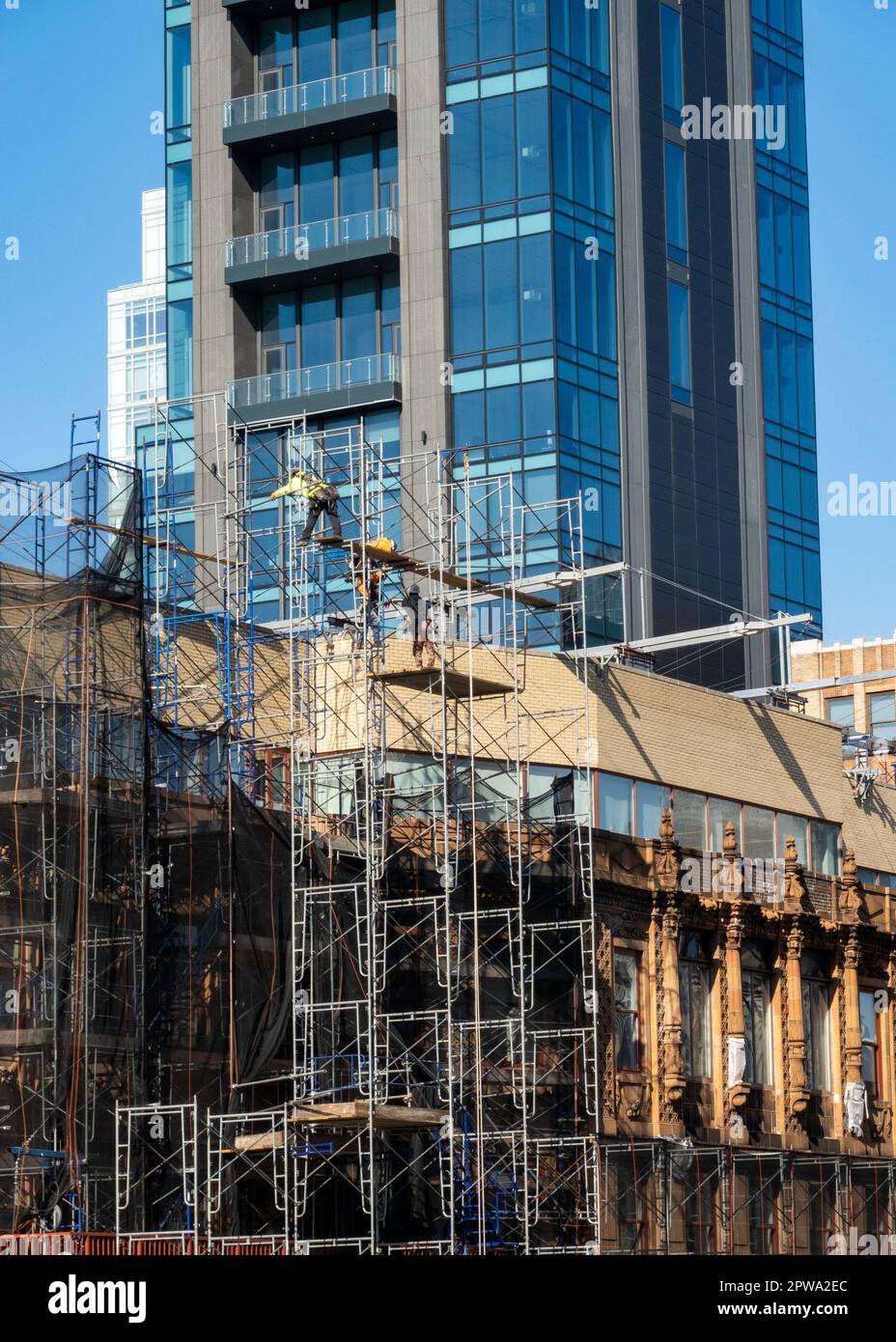 Workers constructing repointing scaffolding on an office building on ...