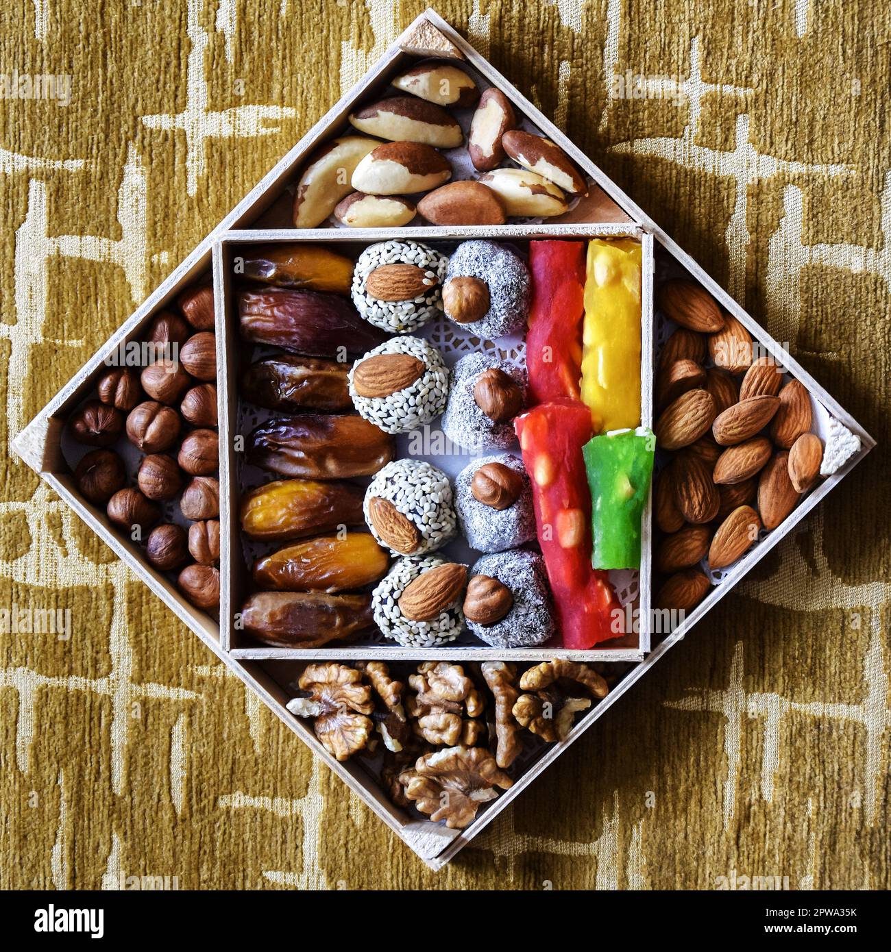 Colorful set of nuts and dried fruits in wooden package. Healthy eating ...
