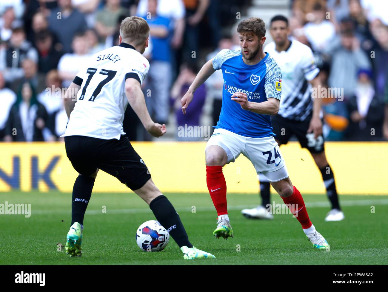 Portsmouth's Michael Jacobs (right) and Derby County's Louie Sibley ...