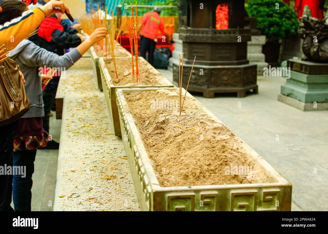 Incense sticks in a Chinese temple in Hong Kong. People praying at ...