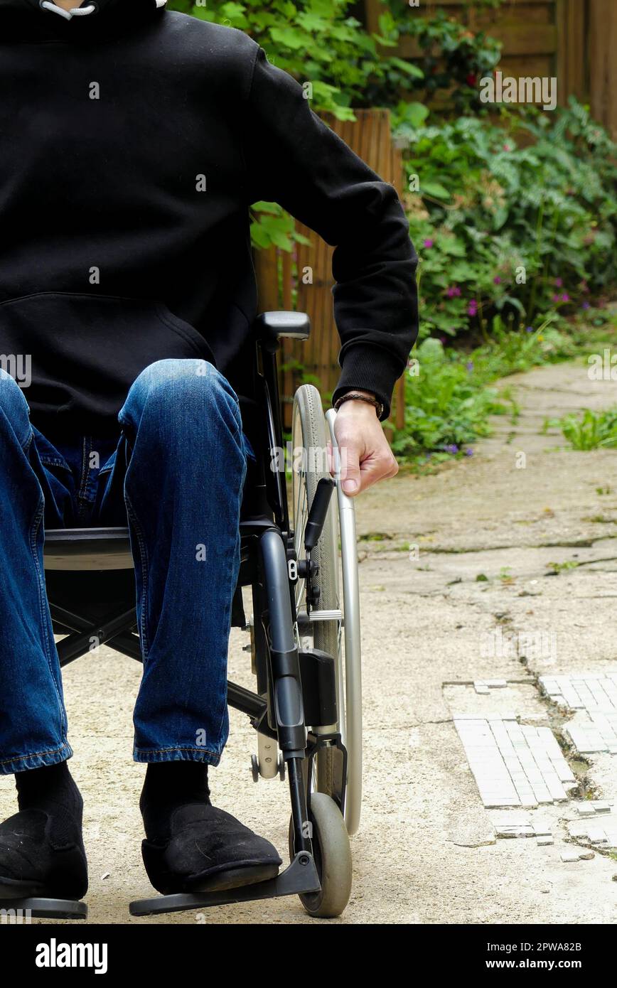 A disabled person in a wheelchair. A man with reduced mobility in an ...
