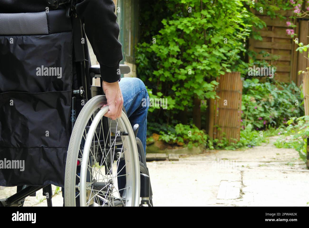 A disabled person in a wheelchair. A man with reduced mobility in an ...