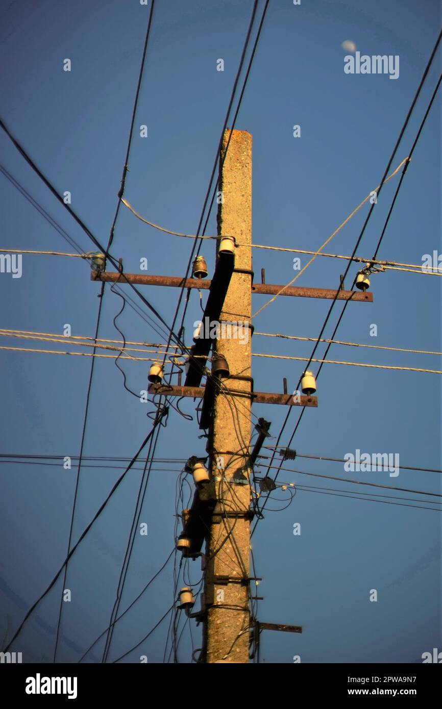 Electric pole in the deep blue sunset sky Stock Photo - Alamy