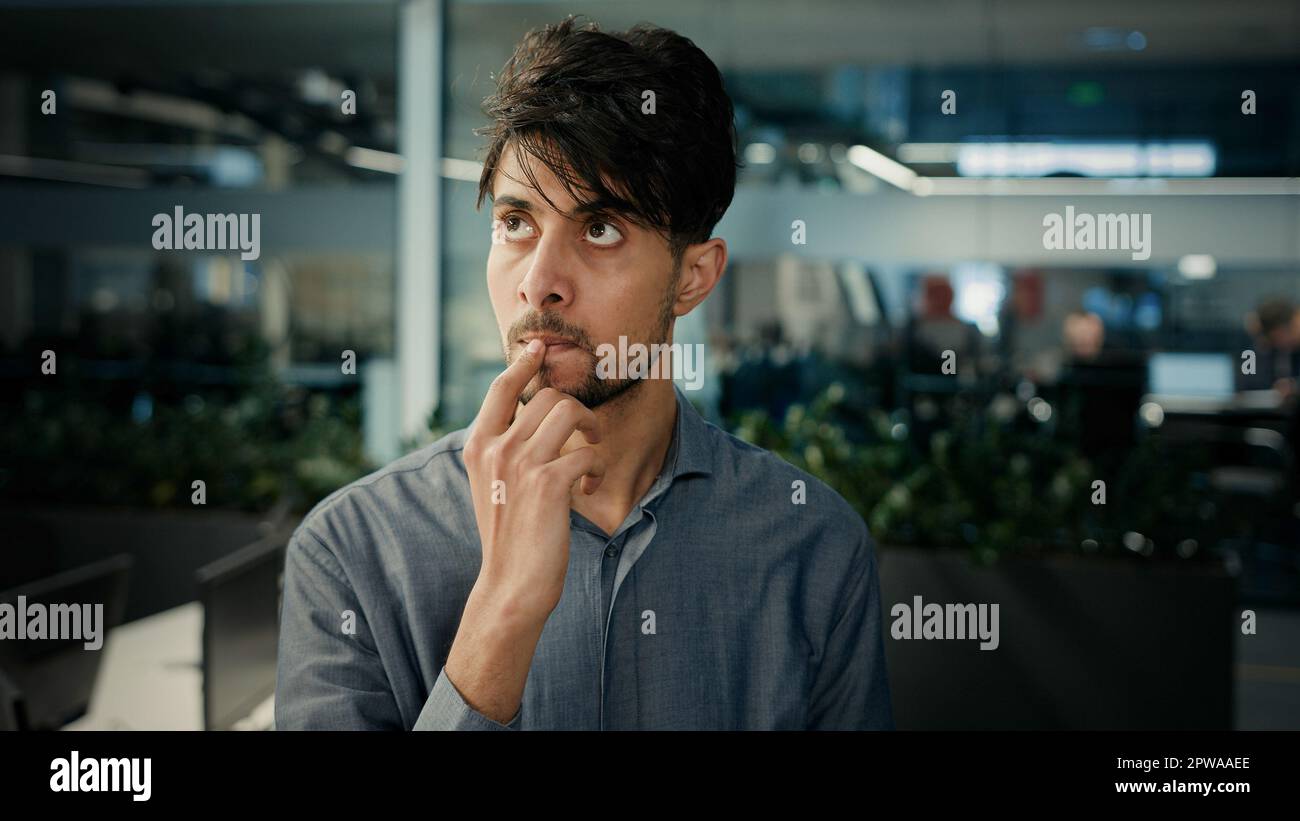 Thoughtful puzzled indian arabian man office manager smart creative ...