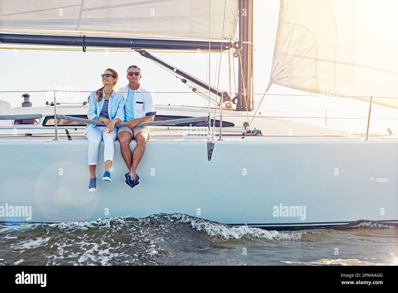 Happiness comes in salty water. a couple enjoying a boat cruise out on ...