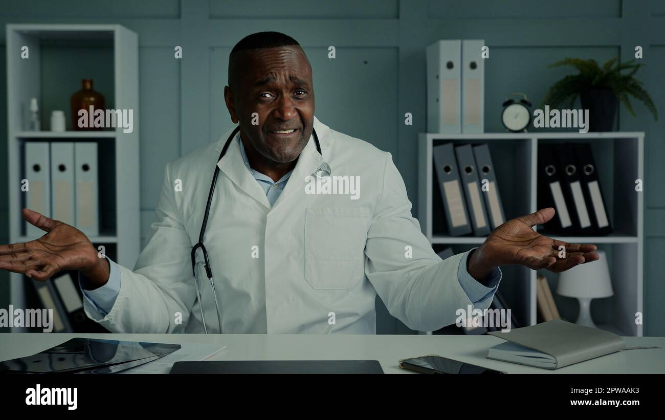 Stressed male doctor desperate sad elder surgeon african man worried ...