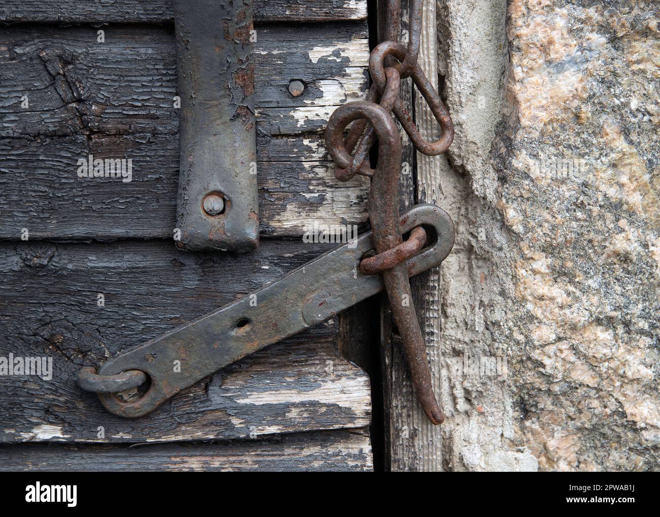 Old hook on closed door Stock Photo - Alamy
