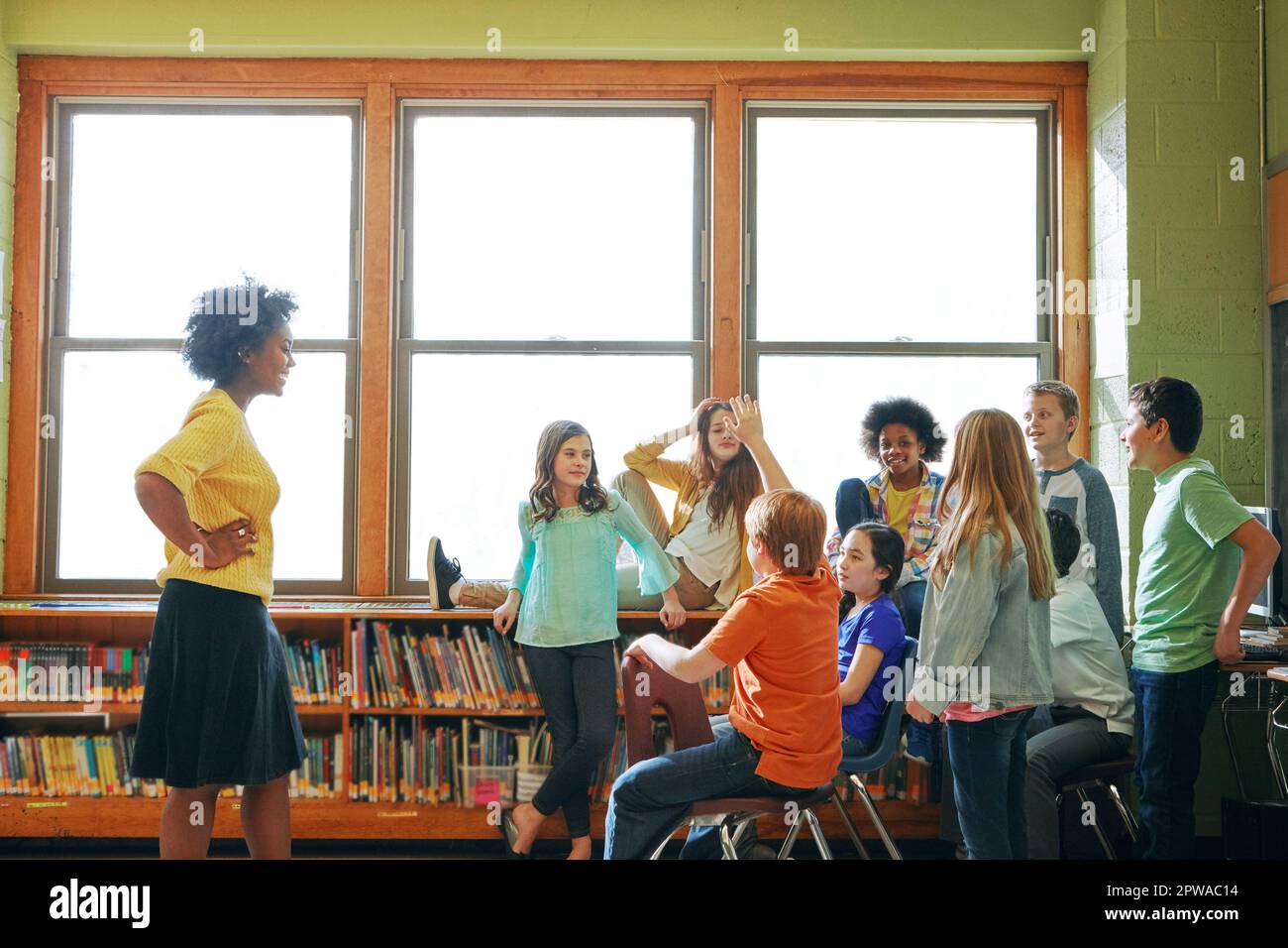 Learning so many new things today. a young boy raising his hand to ...