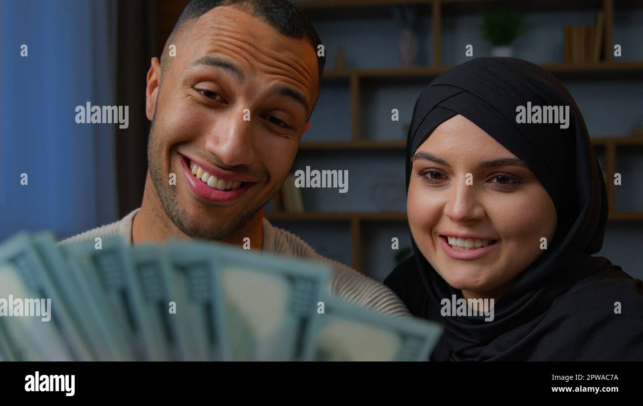 Rich multiracial couple spouses African American man counting money ...