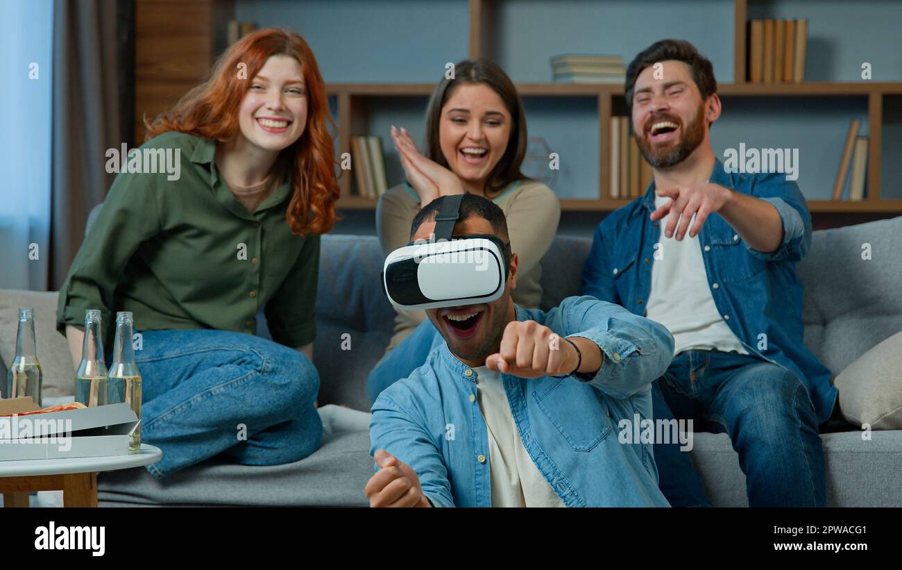 Gaming group multiracial ethnic diverse friends women men on couch ...