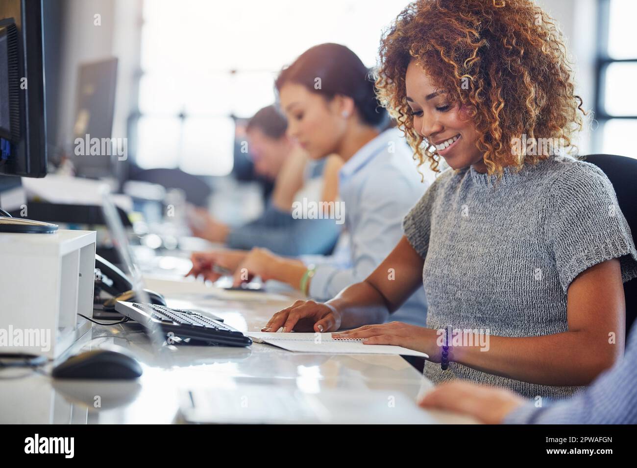 Sometimes she impresses herself. a group of businesspeople working in ...