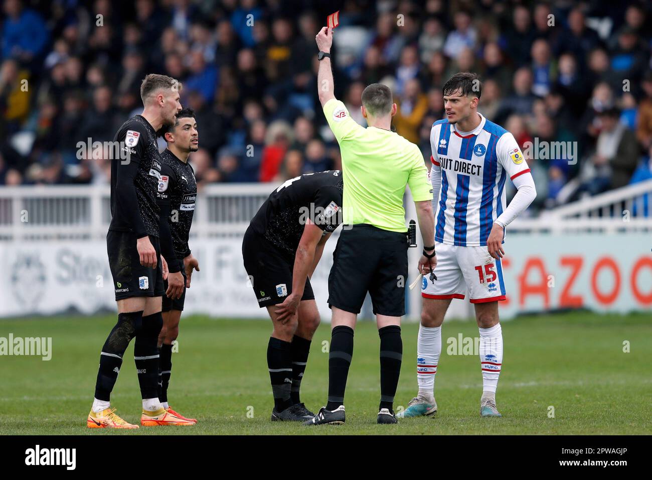 Barrow's Harrison Neal (centre) is shown a red card after being shown ...