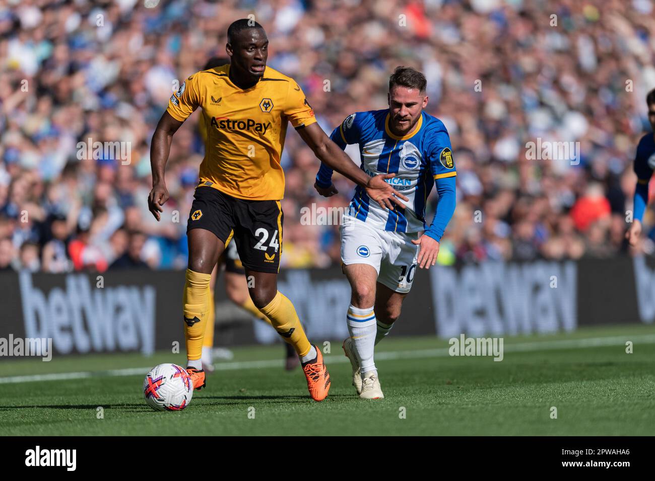 Toti Gomes of Wolverhampton Wanderers shields the ball from Alexis Mac ...