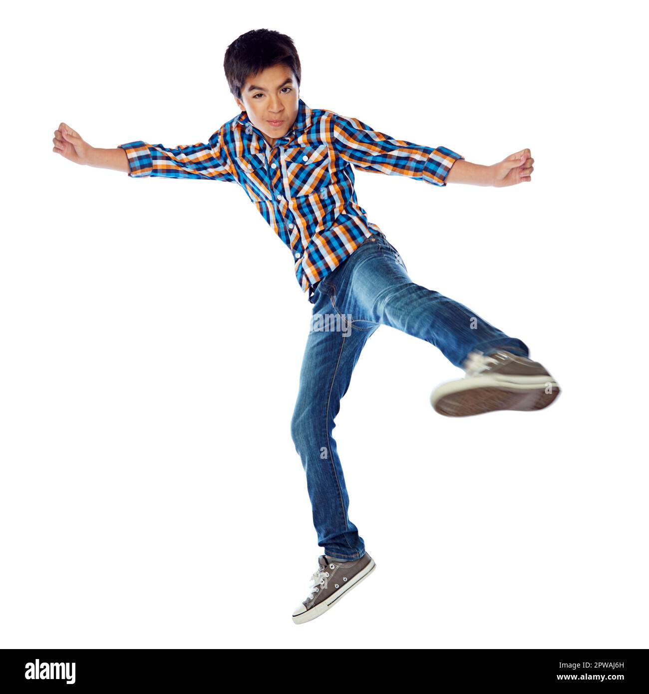 Time to spring into action. Studio shot of a young boy jumping ...