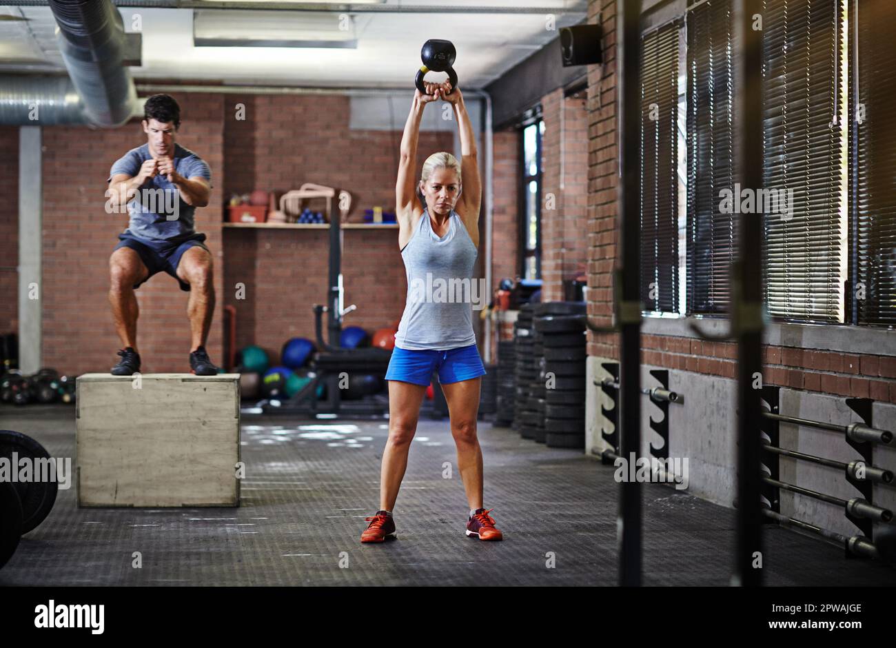 Pushing themselves just a little more than the rest. two people working ...
