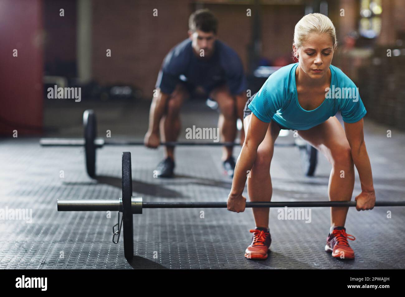 Preparing for the frst pull. two people lifting weights in a gym Stock ...