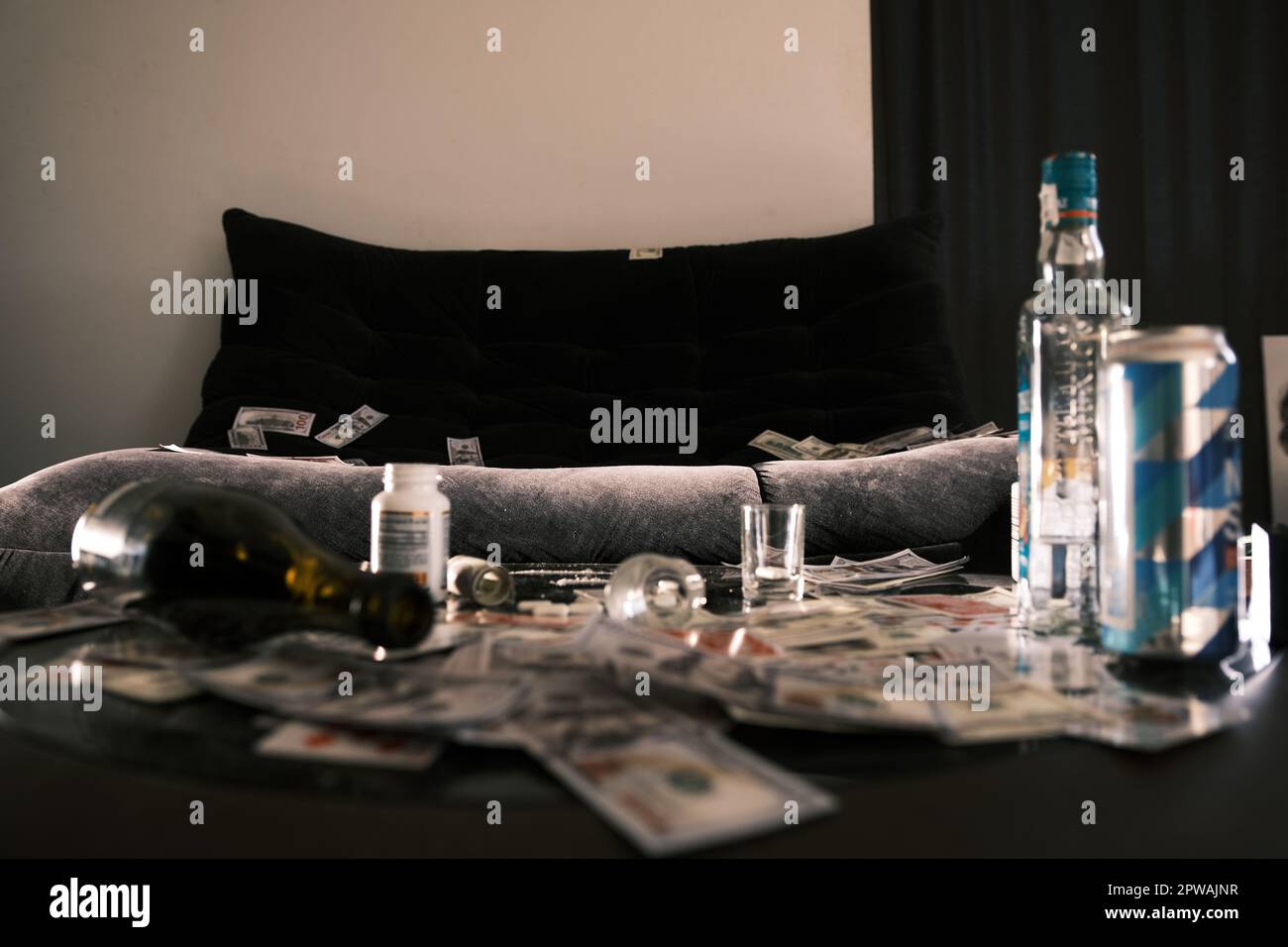 scene with sofa and table scattered Alcohol drink, pills, needle, drugs ...