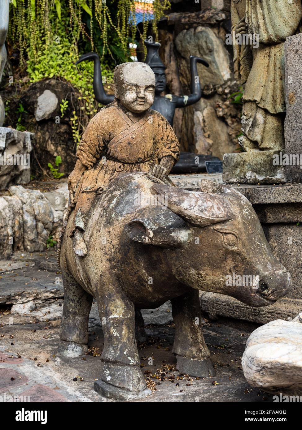 In the photo, a closeup of a statue of a serene Buddhist monk riding a ...