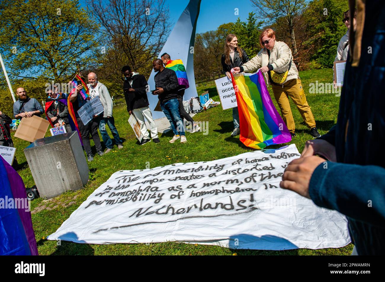 Protesters are seen placing banners in support of LGBTQIA asylum ...