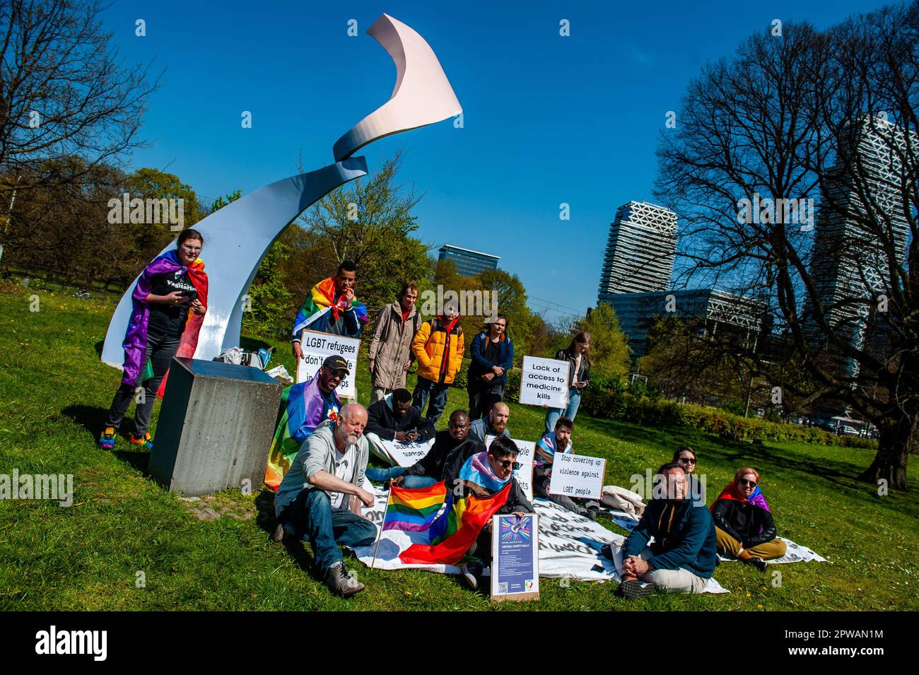 Protesters with rainbow flags seen sitting in front of the ...