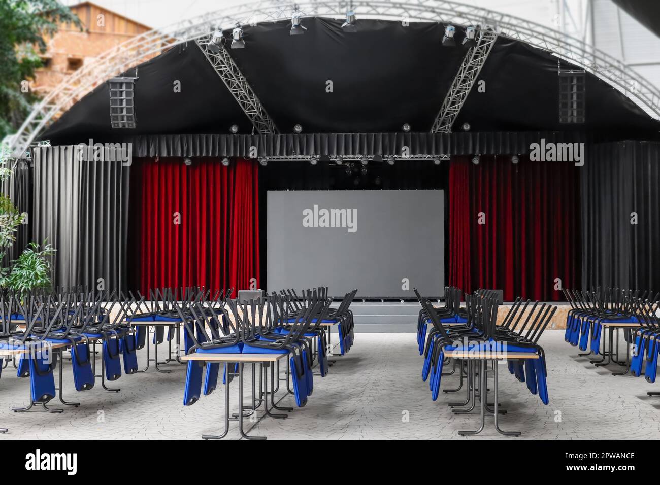 View of outdoor cinema with projector screen, chairs and tables Stock ...