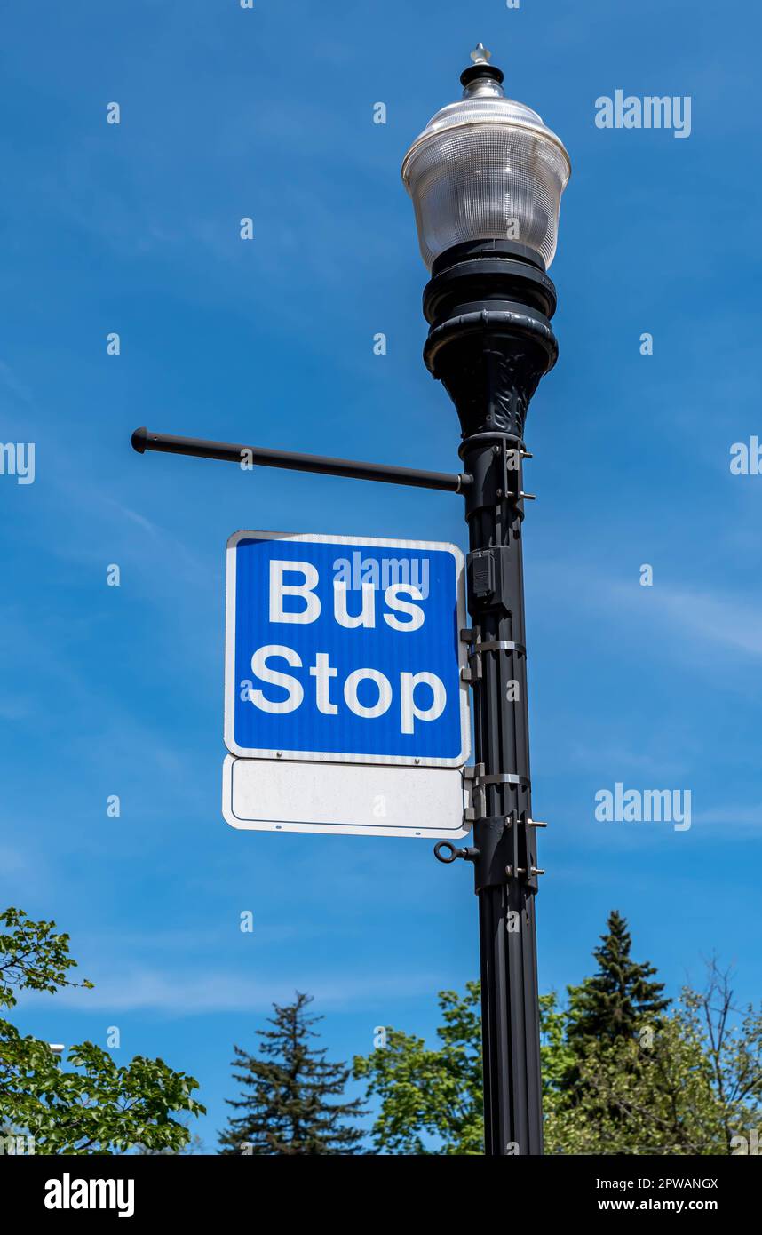 A bus stop sign on a lamp pole in Pittsburgh, Pennsylvania, USA on a ...
