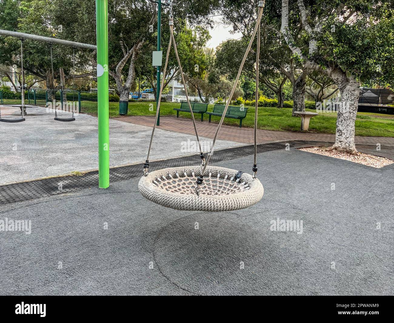 View of nest swing on children's playground Stock Photo - Alamy