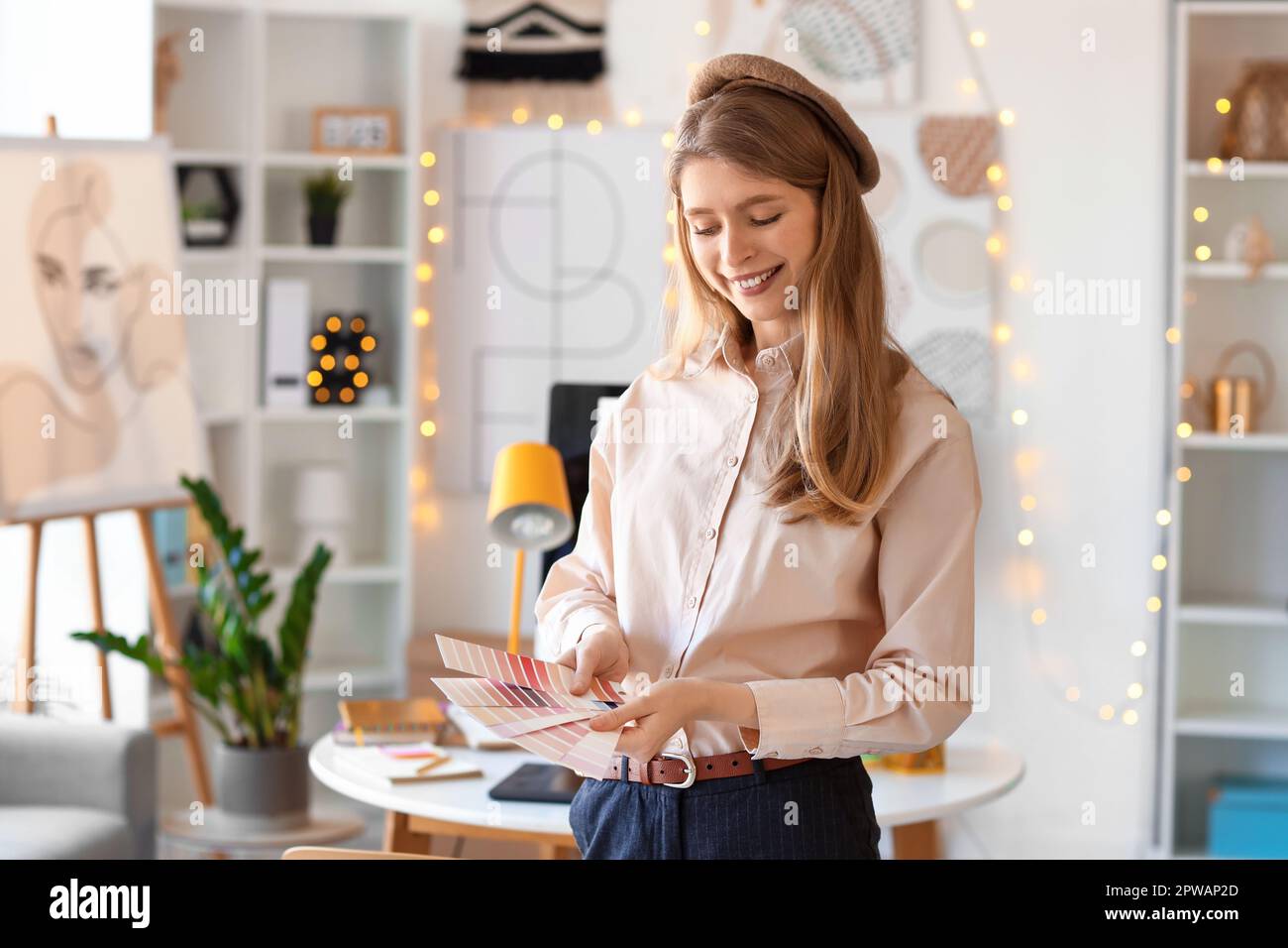 Female graphic designer with color palettes in office Stock Photo - Alamy