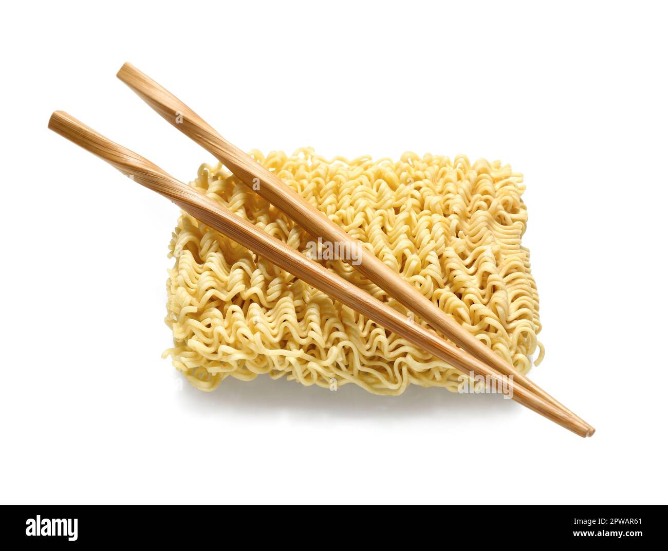 Raw instant noodles and wooden chopsticks on white background Stock ...