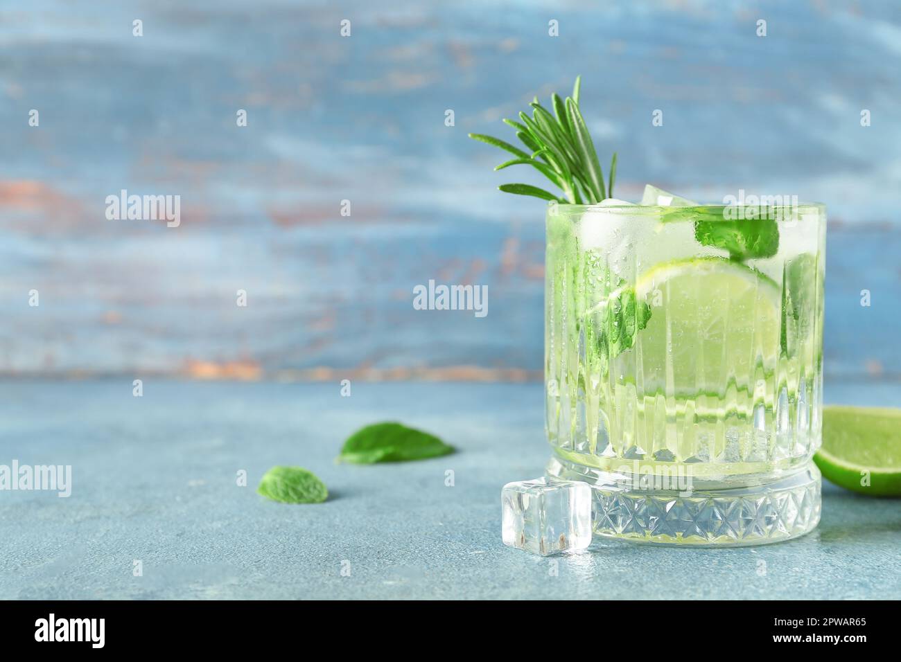 Glass of tasty mojito on blue background Stock Photo - Alamy