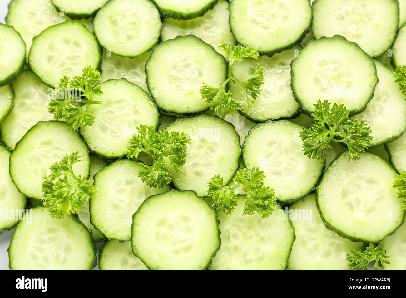 Texture of sliced cucumber with parsley Stock Photo - Alamy