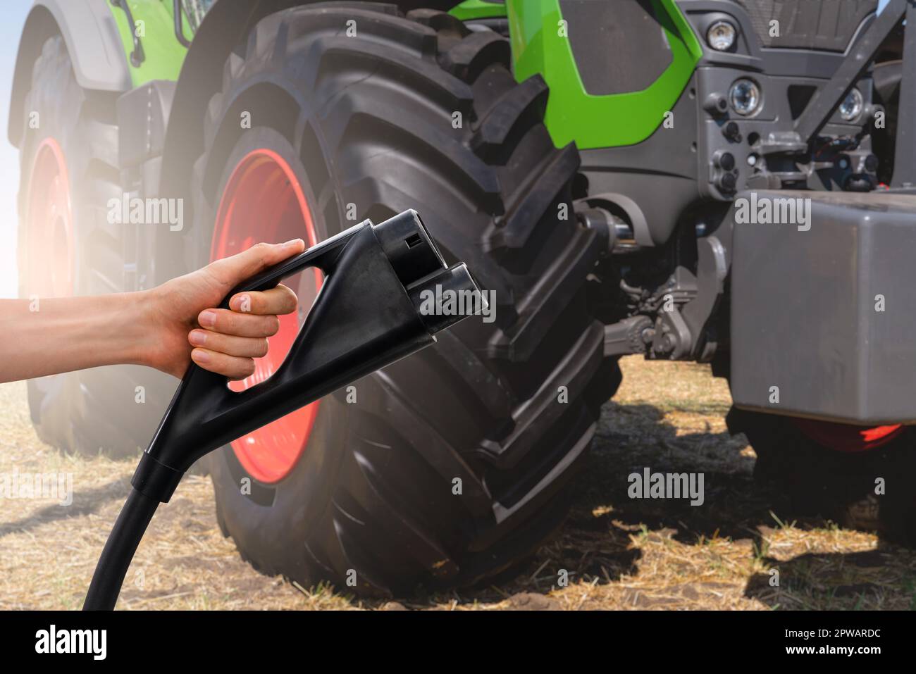 Hand with electric vehicles charging plug on a background of ...