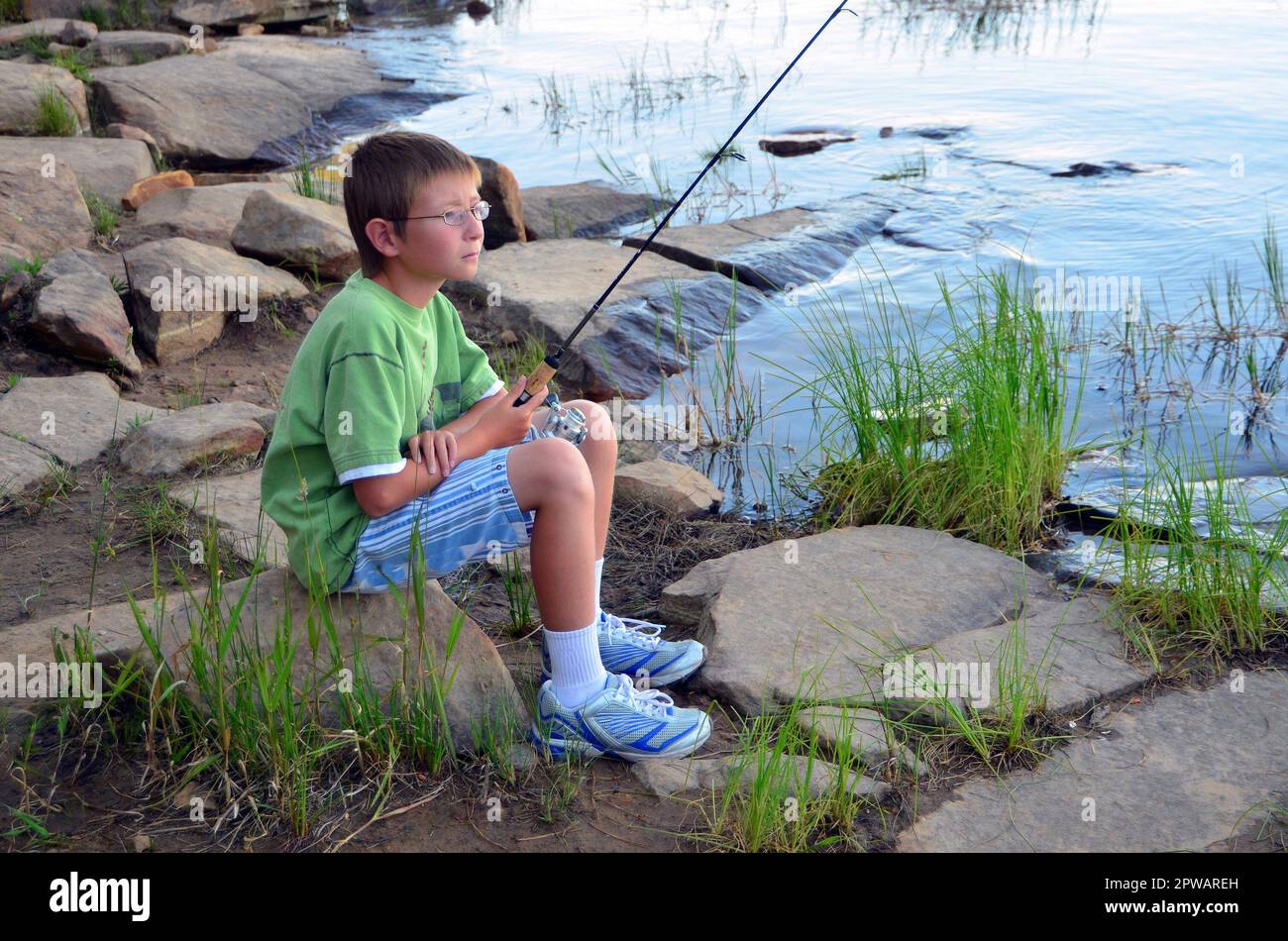 Young boy fishing in a forest lake Stock Photo - Alamy Young boy fishing in a forest lake Stock Photo - Alamy