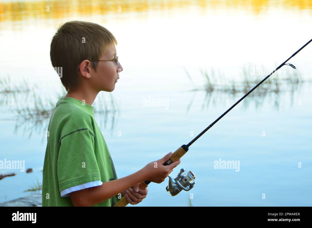 Young boy fishing in a forest lake Stock Photo - Alamy Young boy fishing in a forest lake Stock Photo - Alamy