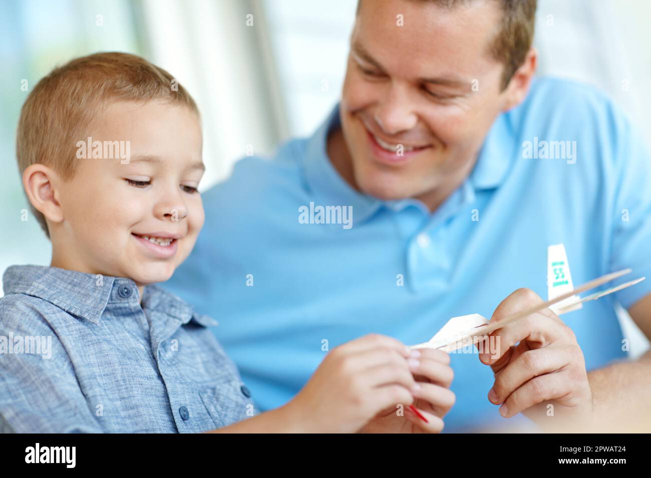 Attaching the propeller. a young boy smiling while playing model ...