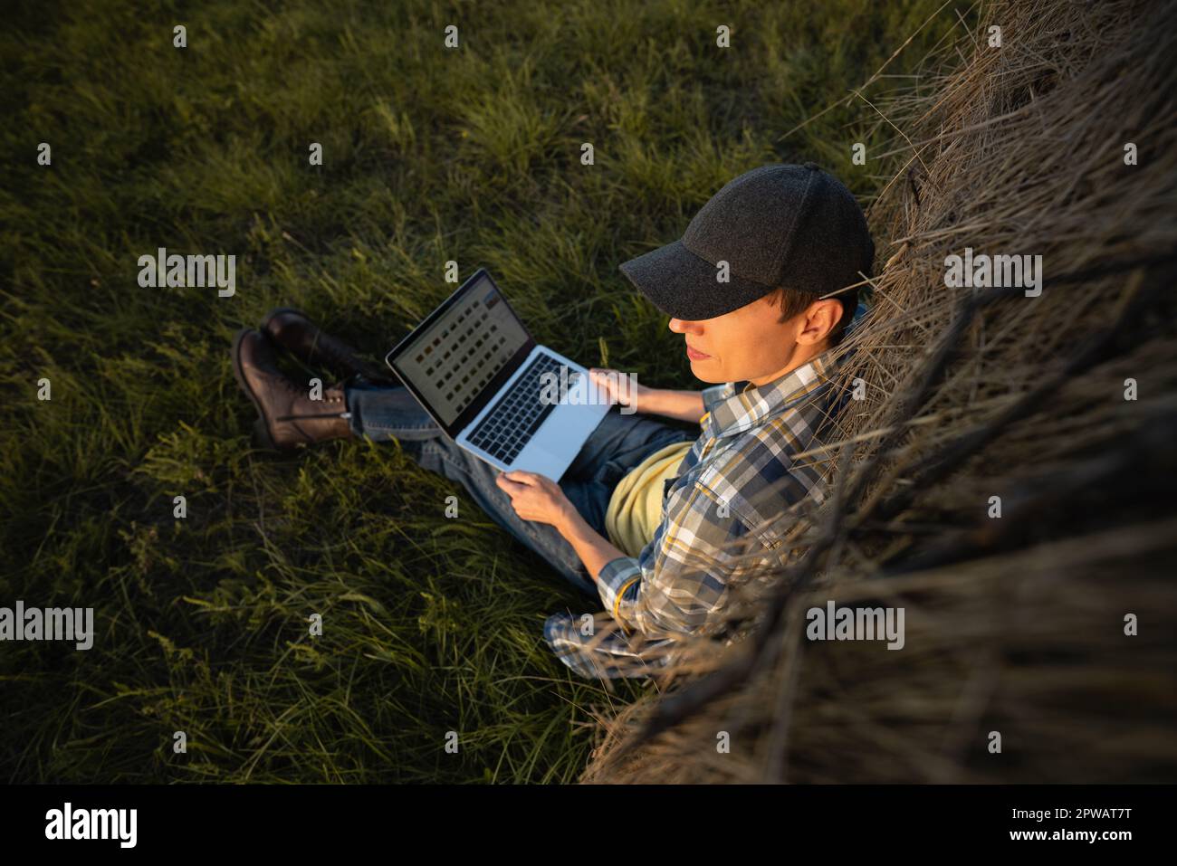 Farmer with laptop on the field. Smart farming and agriculture ...