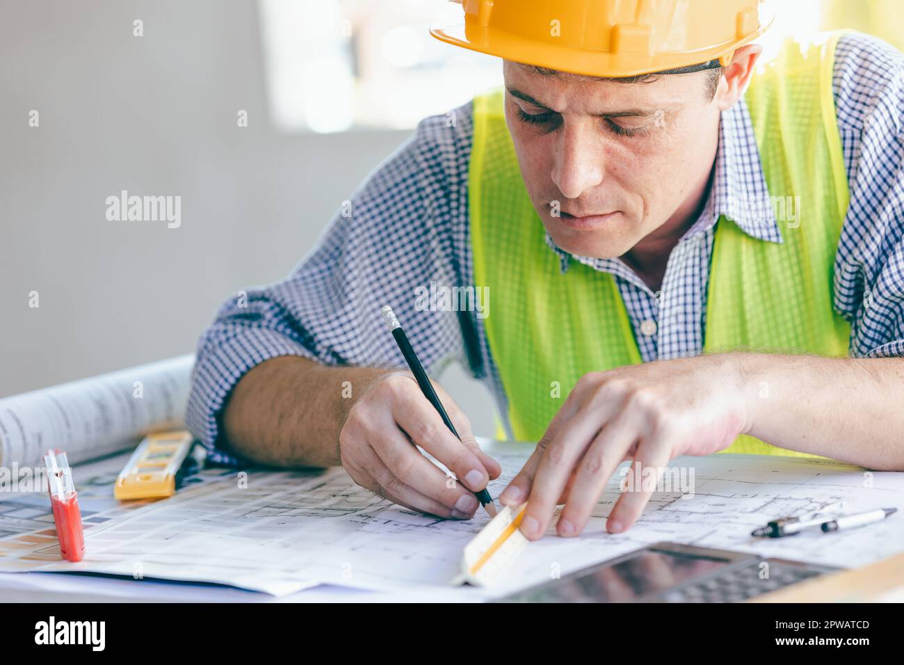 Architect Engineer Builder, Building Designer working with floorplan at ...