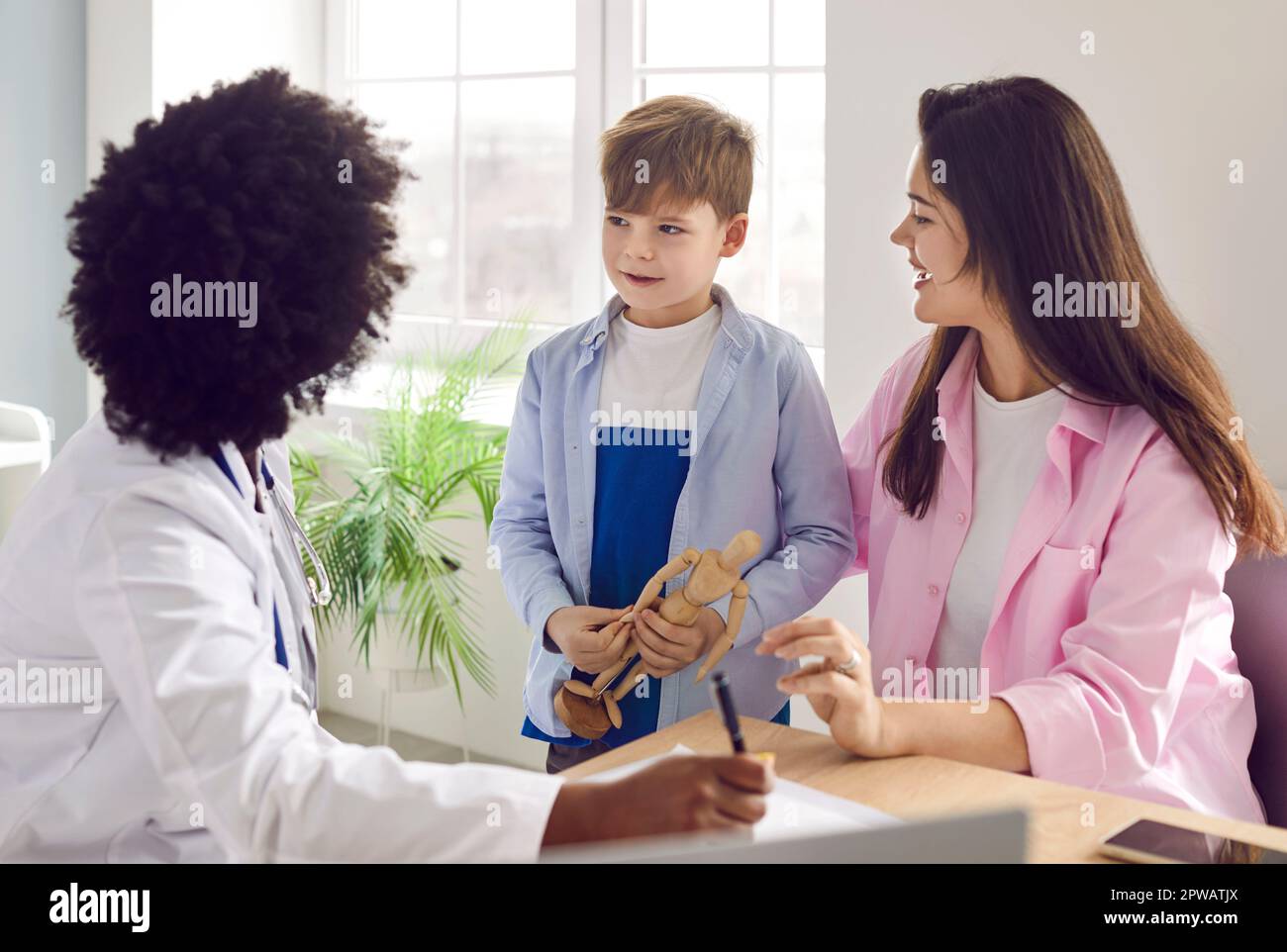 Child boy patient with his mother listening the female doctors ...