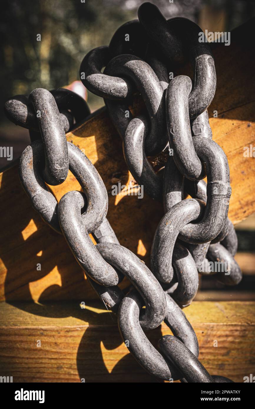 Large metal chain wrapped around a wooden gate. Concept strength ...