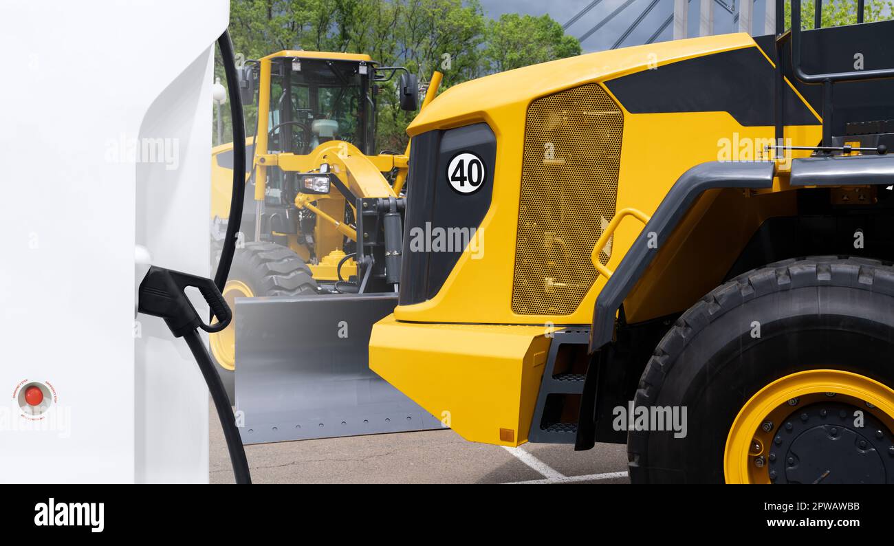 Electric construction machines with charging station. Concept Stock ...