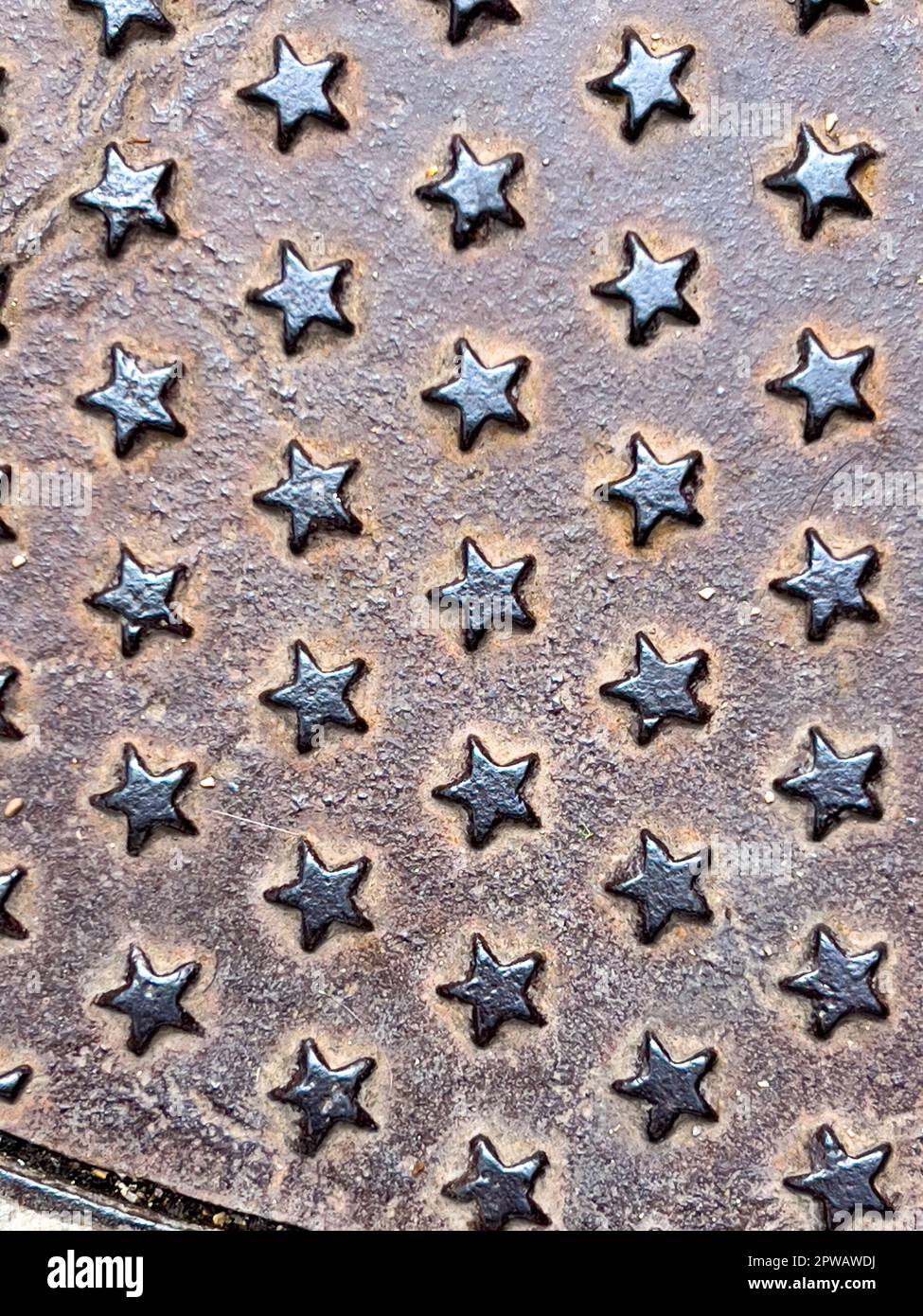 Metal stars of steel texture on a sewer manhole Stock Photo - Alamy