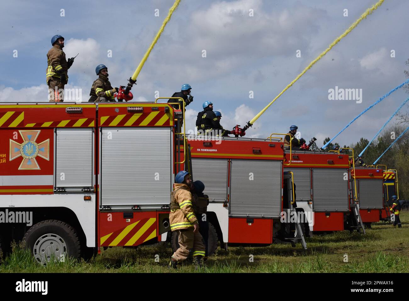 Members of the Ukrainian State Emergency Service standing on fire ...