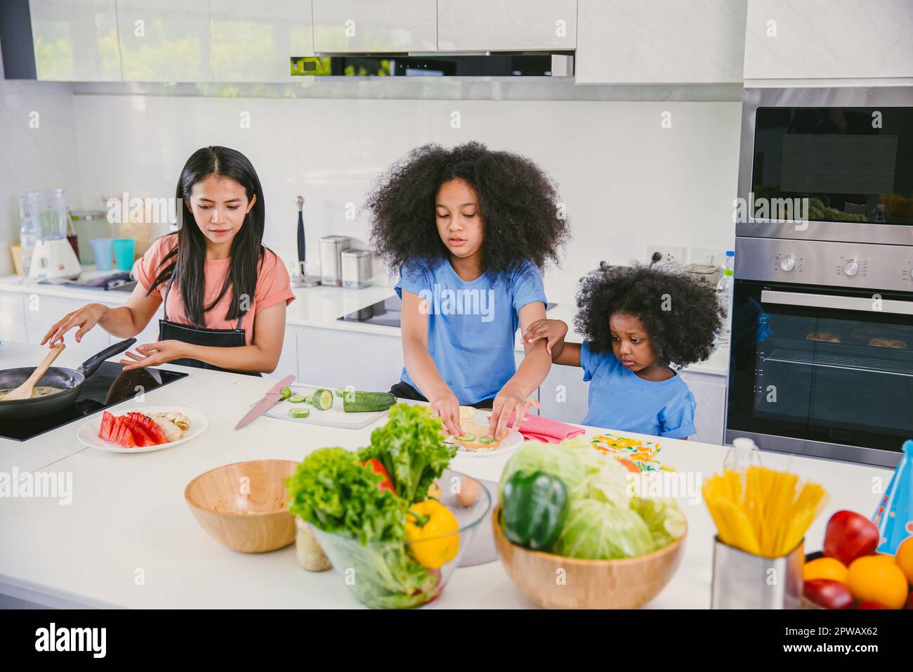 Happy family cooking healthy food together at home kitchen holiday ...