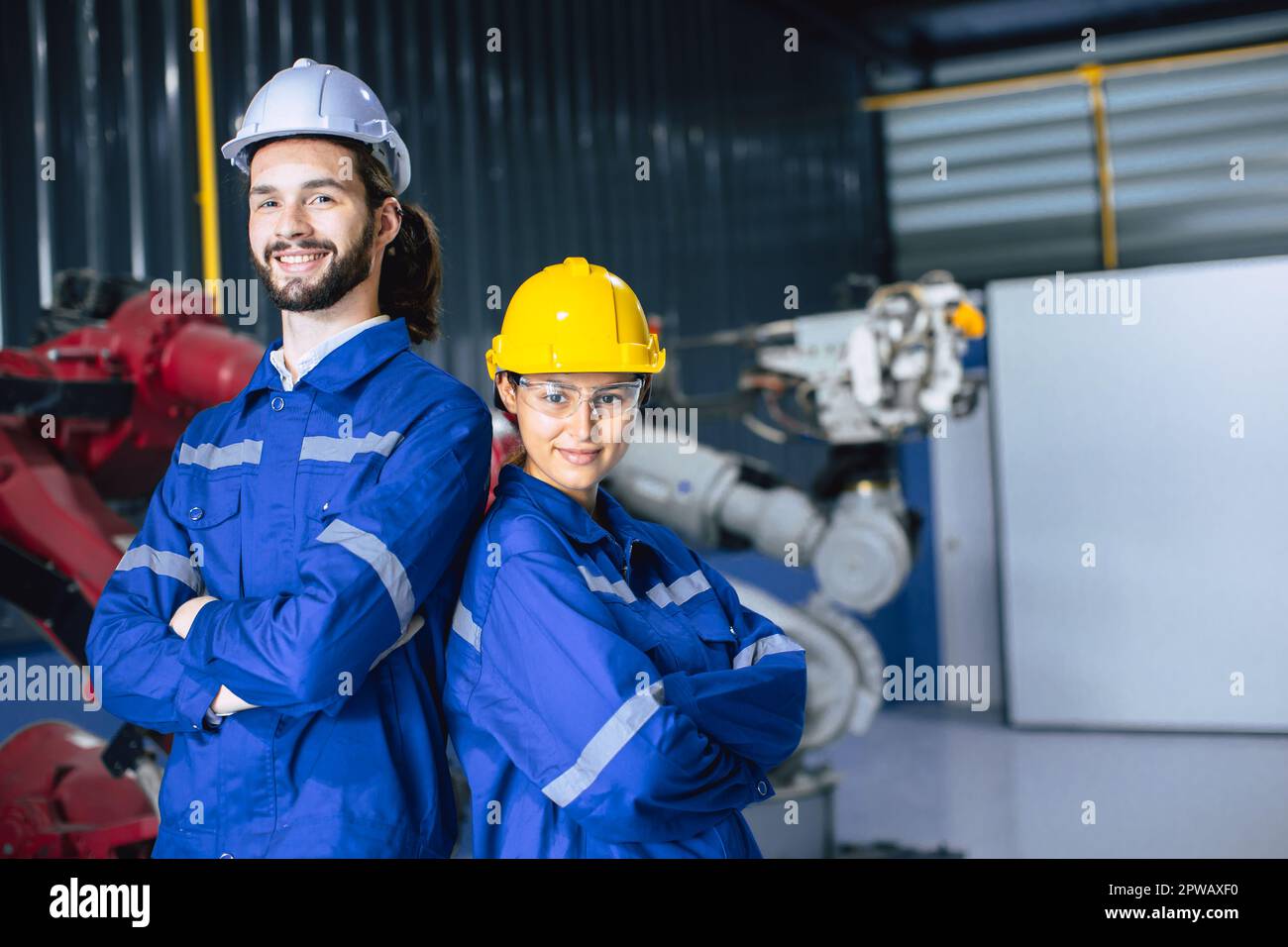 Two technician man and woman engineer worker standing smile in robot ...