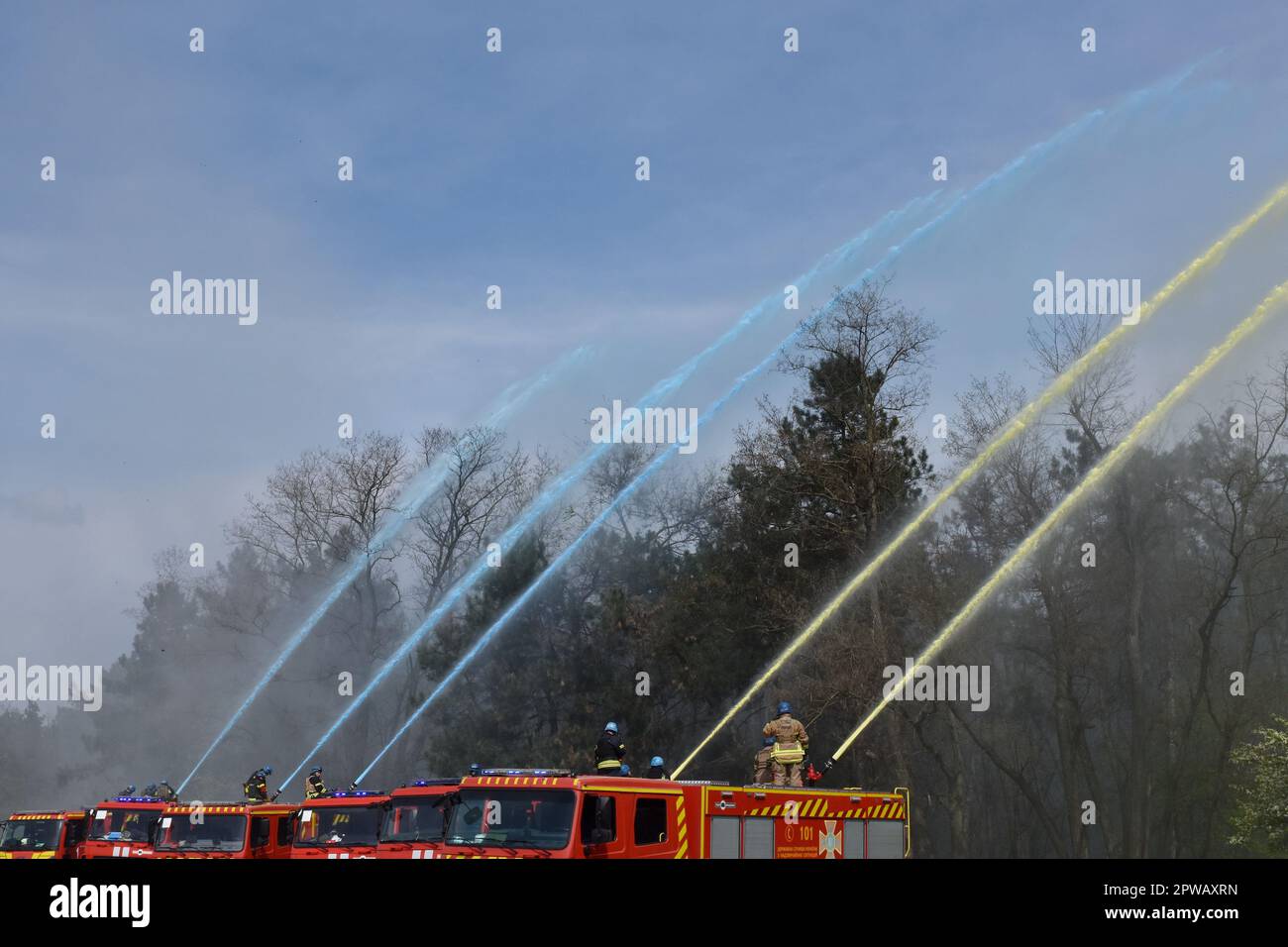 Members of the Ukrainian State Emergency Service standing on fire ...