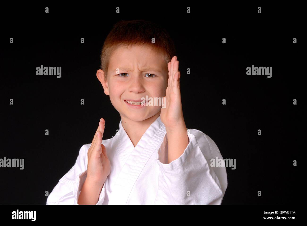 Young boy in karate outfit making fighting movement Stock Photo - Alamy