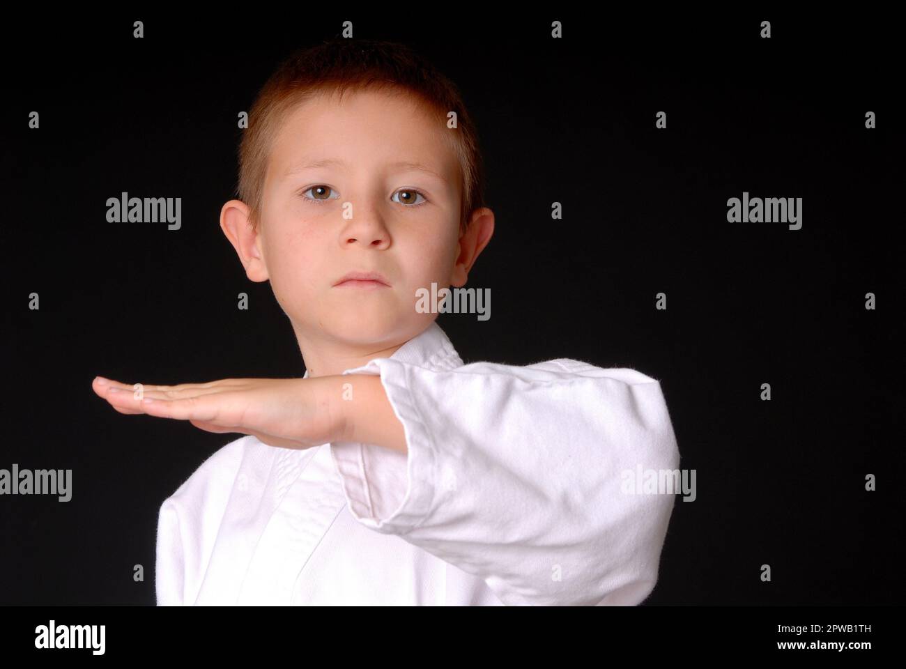 Young boy in karate outfit making fighting movement Stock Photo - Alamy