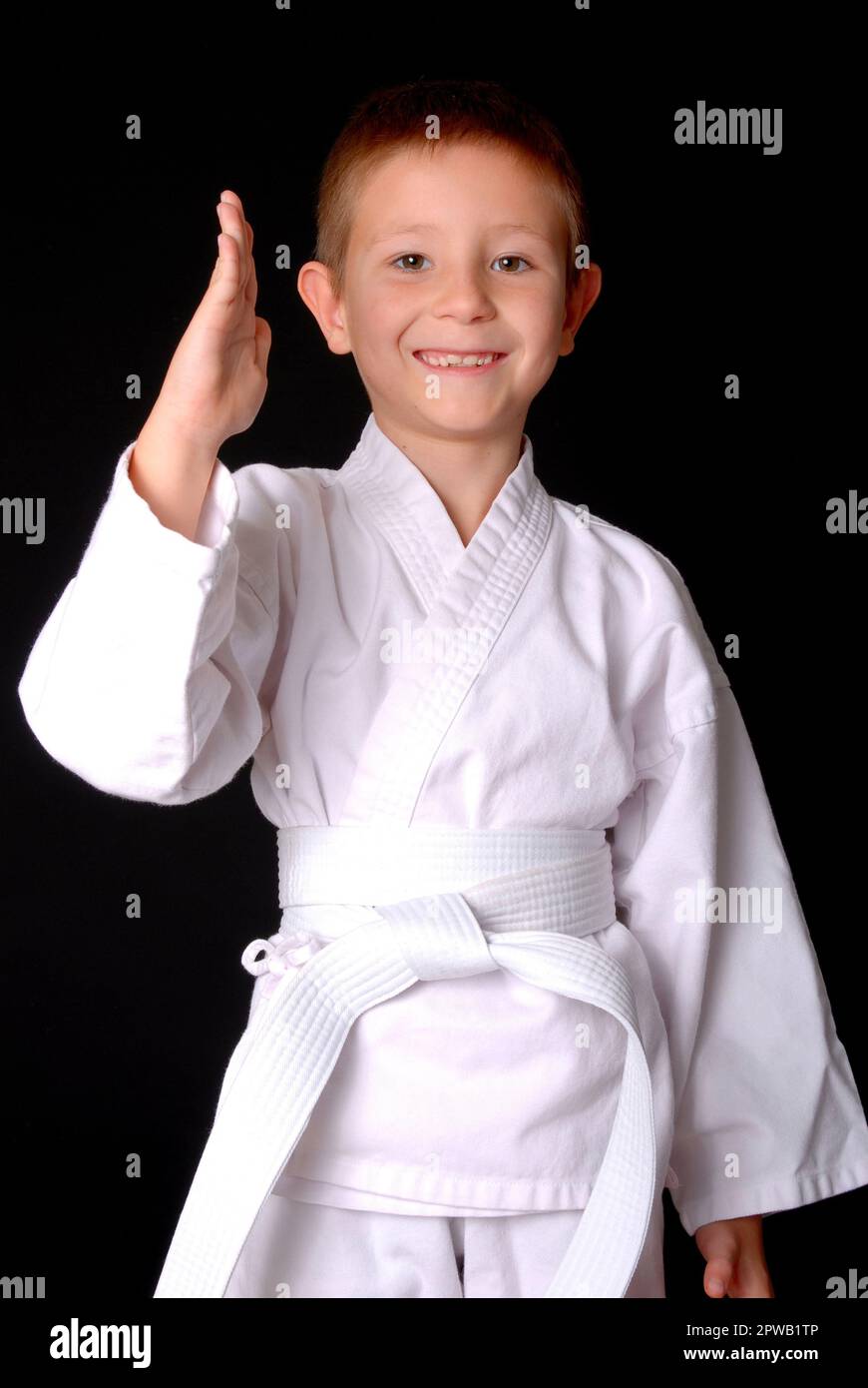 Young boy in karate outfit making fighting movement Stock Photo - Alamy